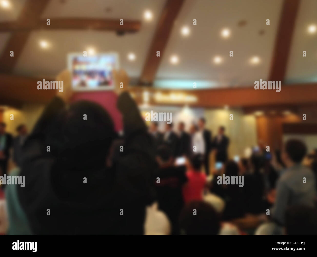 Blurred background of man recording video or taking picture by ...