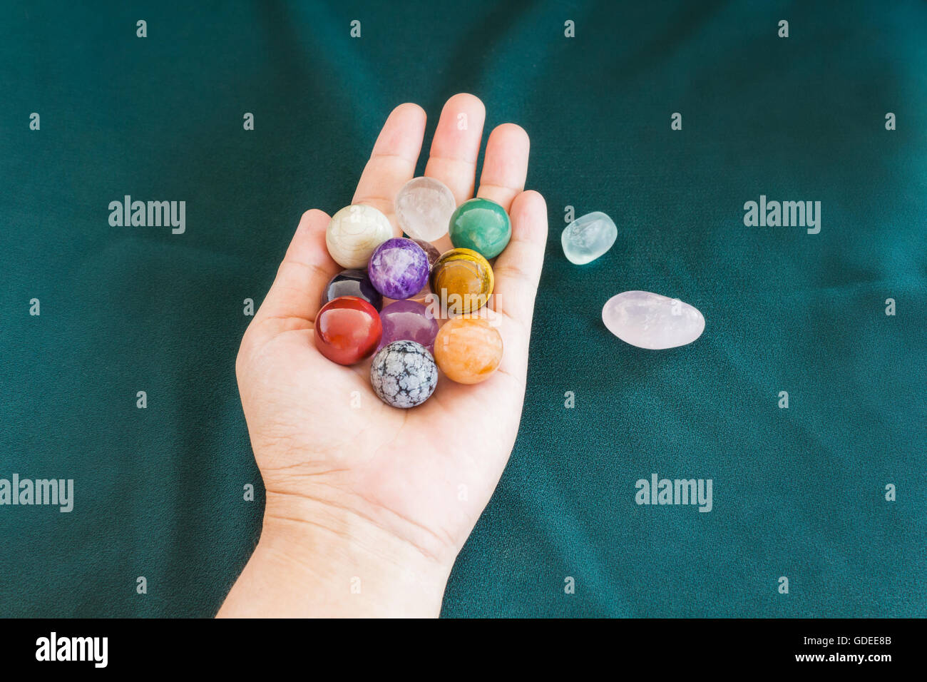 Colourful round stones in hand, quartz Stock Photo - Alamy