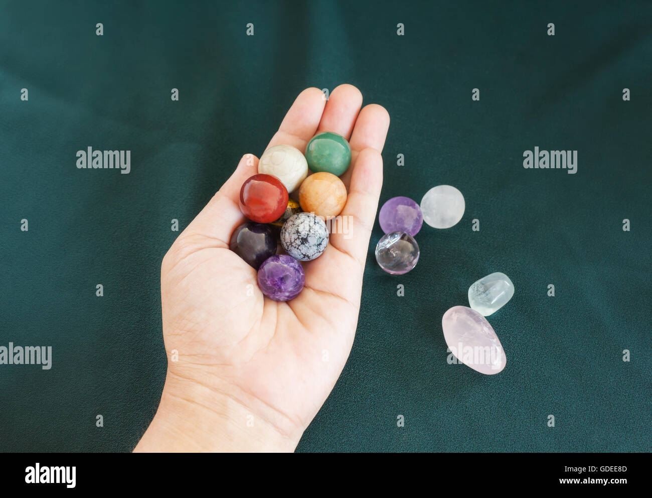 Colourful round stones in hand, quartz Stock Photo - Alamy