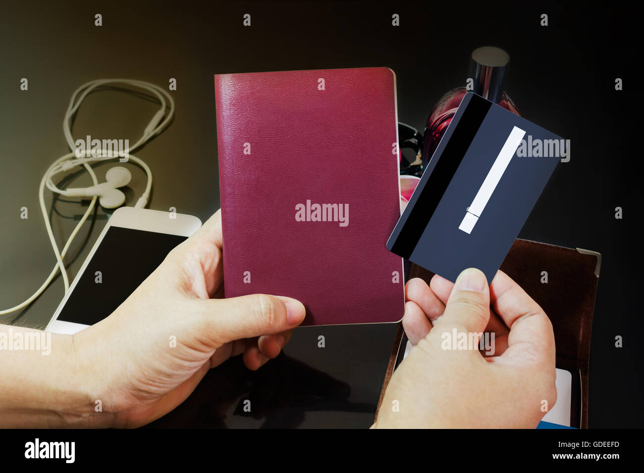 Hands presenting back of blank debit or credit card with empty ...