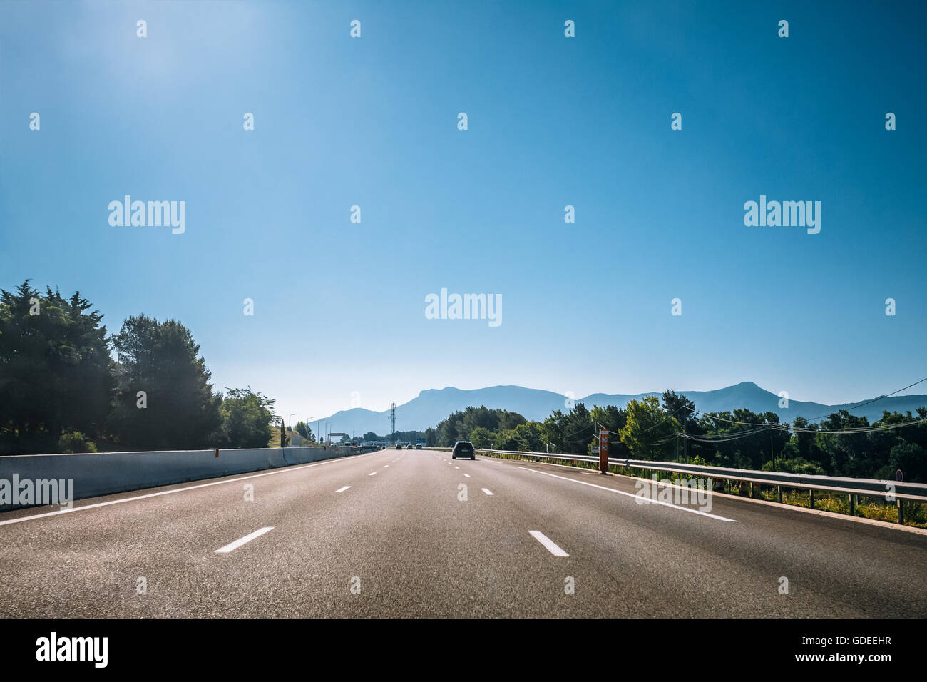 Beautiful asphalt freeway, motorway, highway under sunny clear sky ...