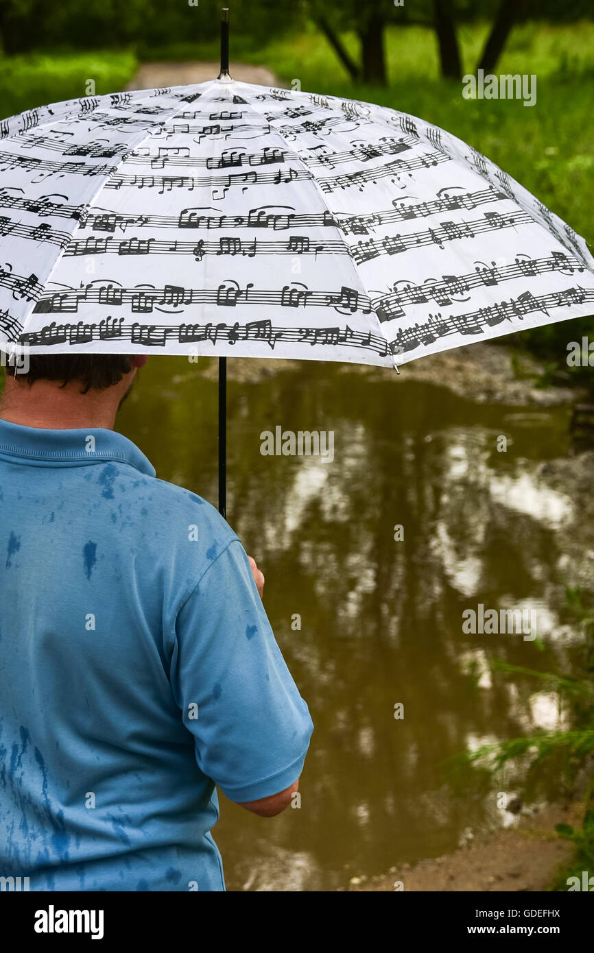 people under an umbrella in the rain Stock Photo - Alamy