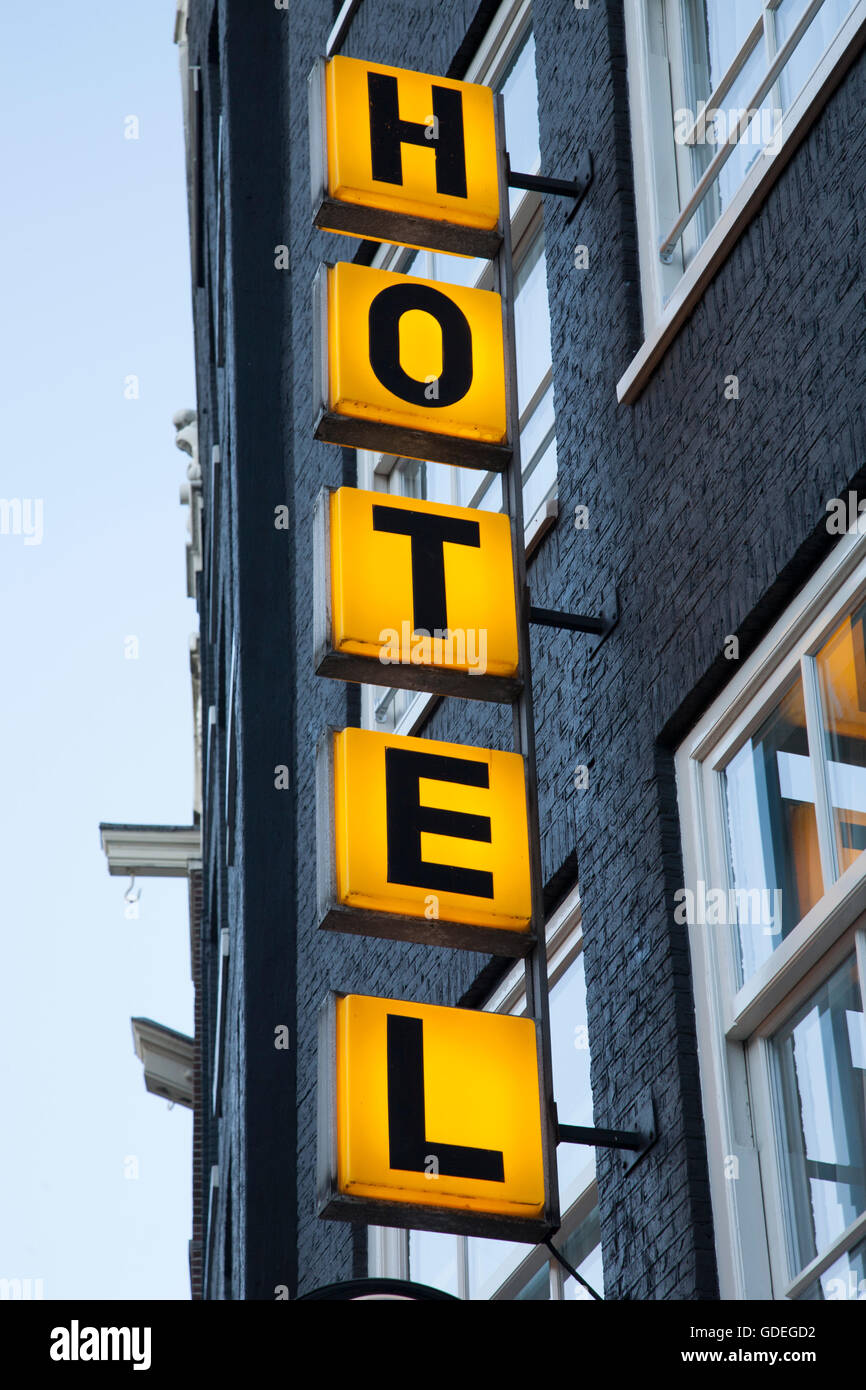 Illuminated Hotel Sign with Building Facade Stock Photo - Alamy