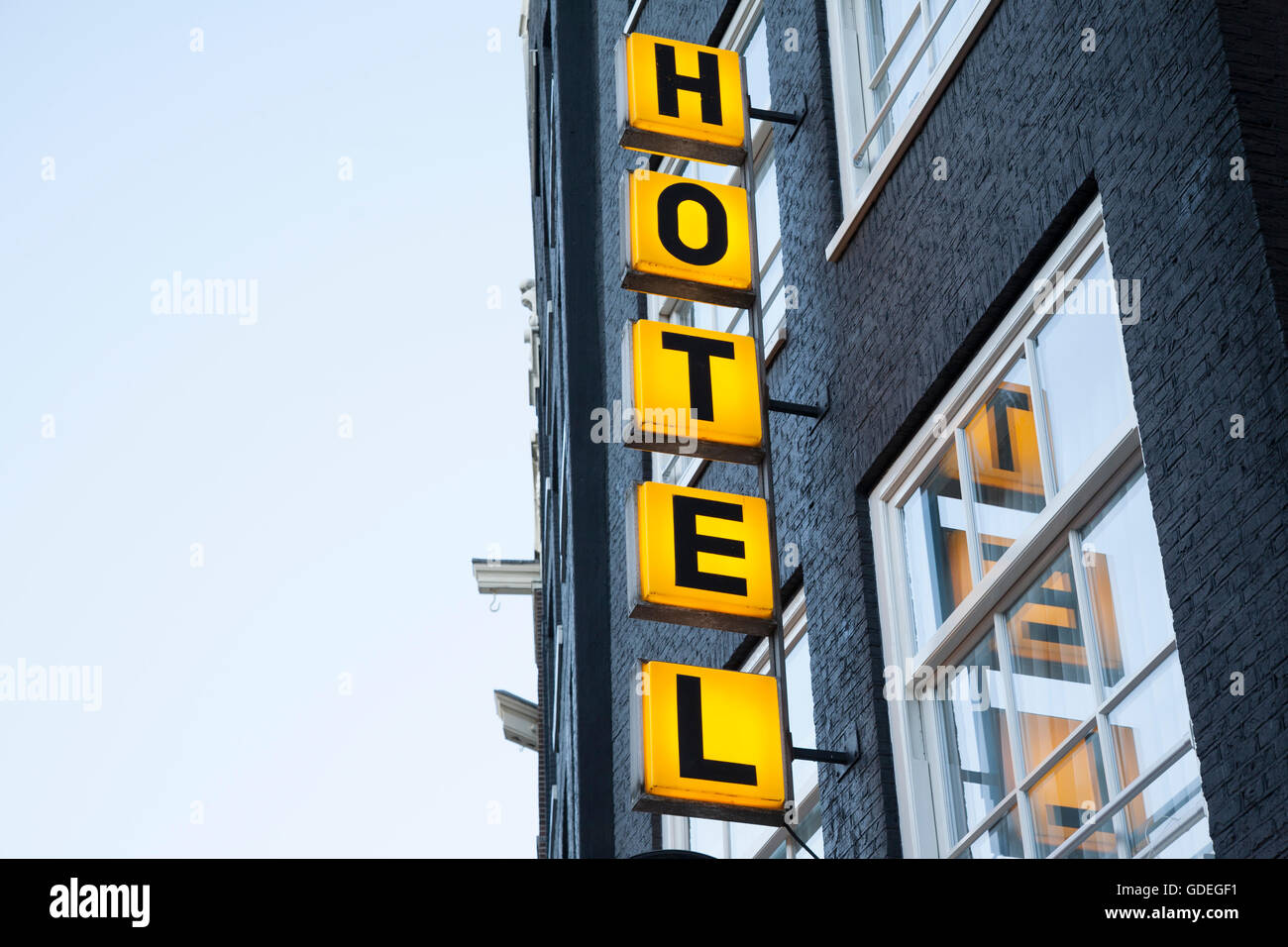 Illuminated Hotel Sign with Building Facade Stock Photo - Alamy
