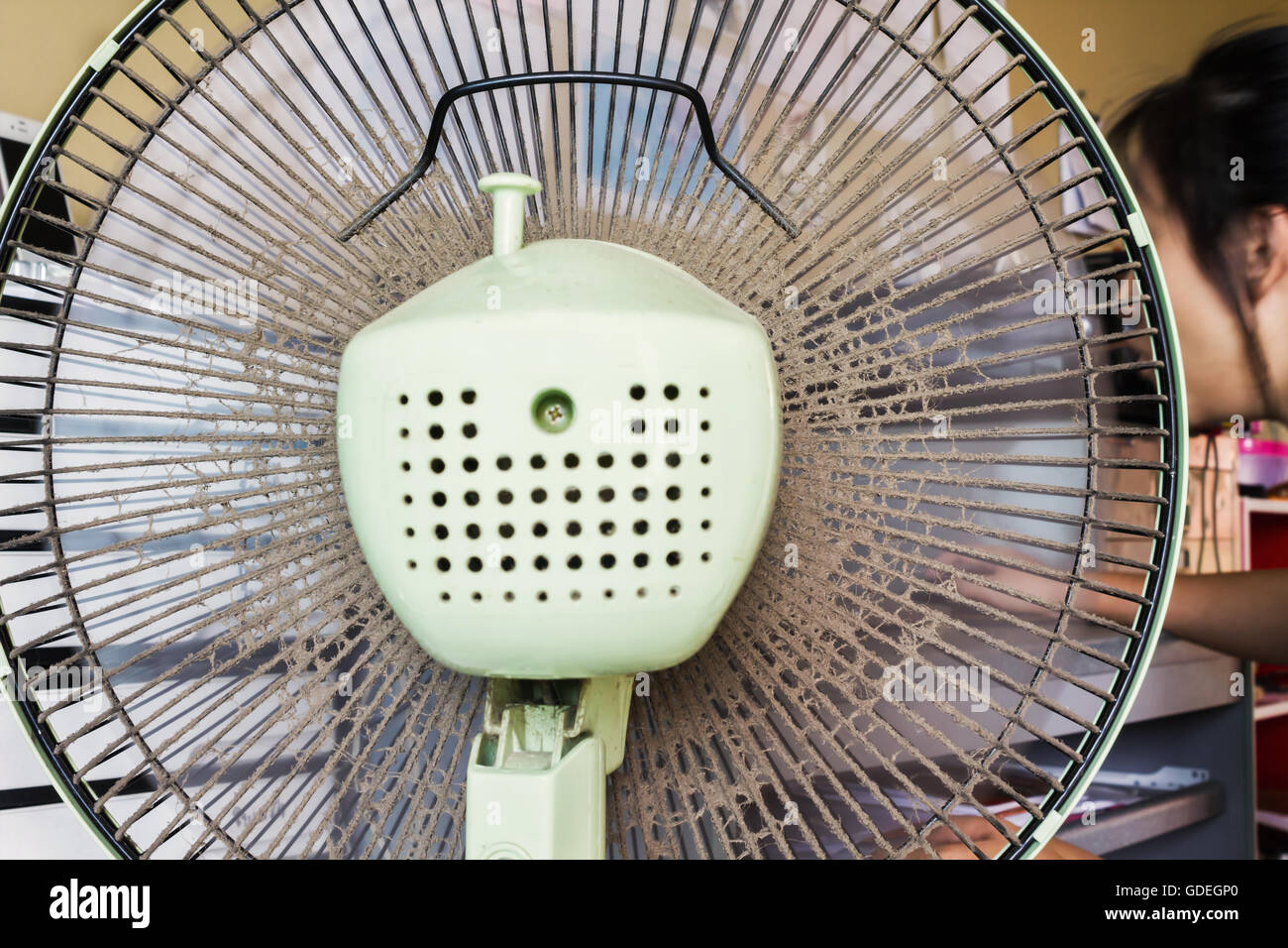 Dusty or unclean portable fan with blurred girl working at table Stock ...