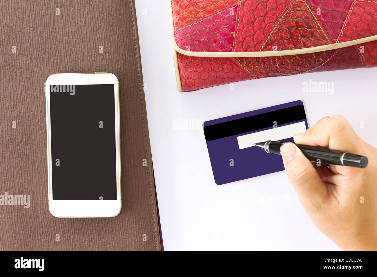 Hand with pen sign or writing down at the back of credit card Stock ...