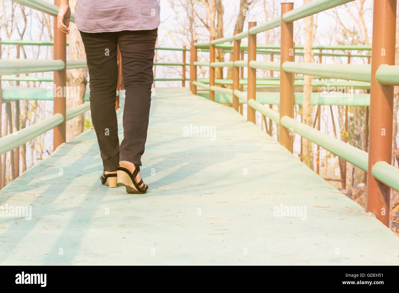 Backside of women leg walking in long pathway of top of mountain or ...