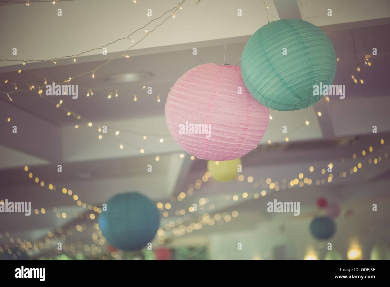 Colored lanterns and fairy lights Stock Photo - Alamy