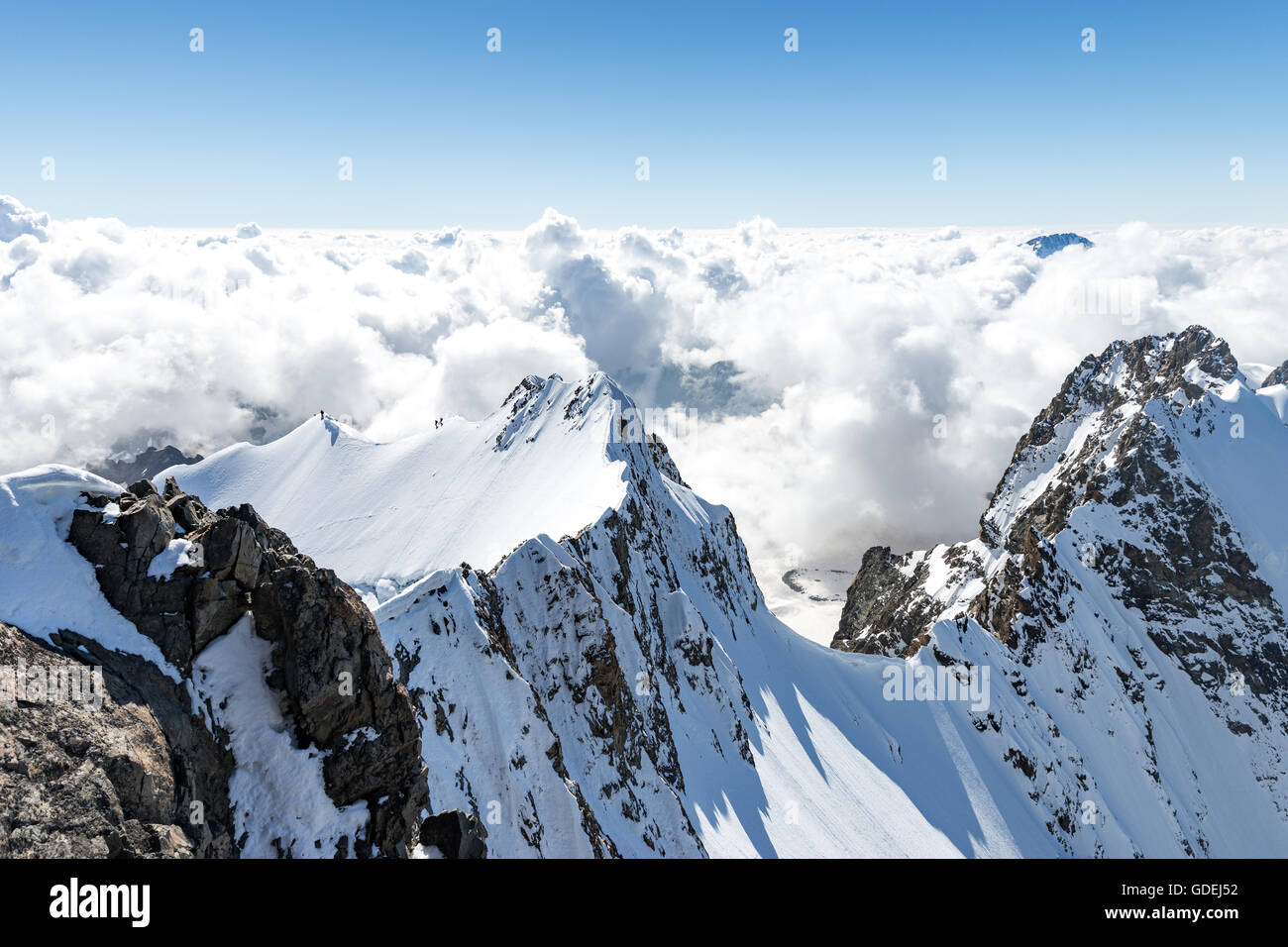 Three People walking along Mountain Ridge in the Swiss Alps, Piz ...