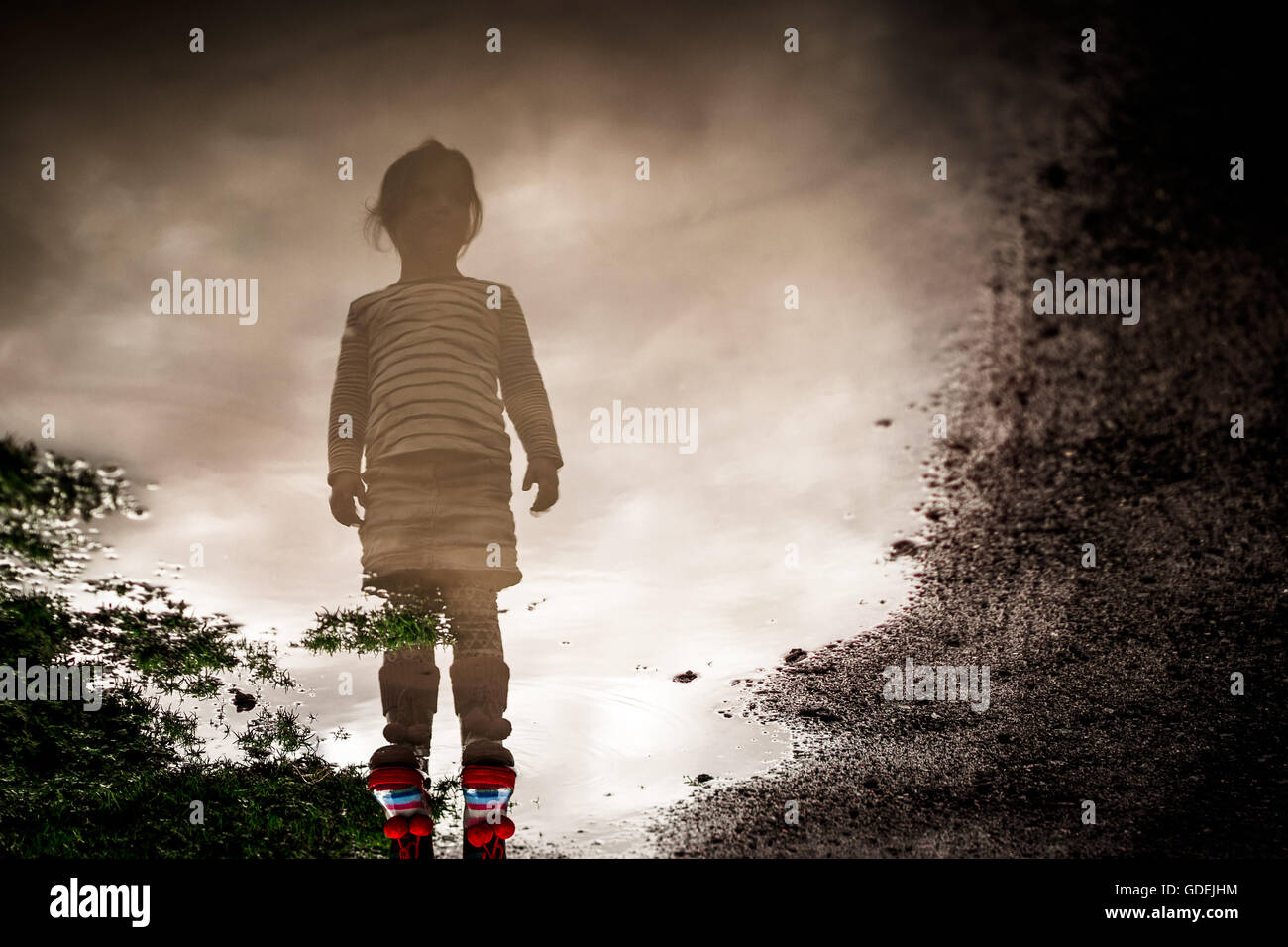 Child looking at reflection in water hi-res stock photography and ...