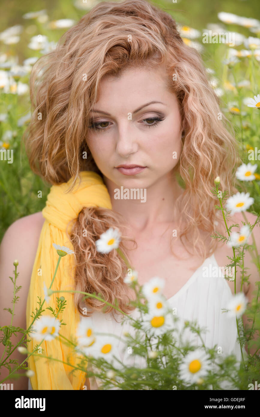 Portrait of a woman in a flower field Stock Photo - Alamy