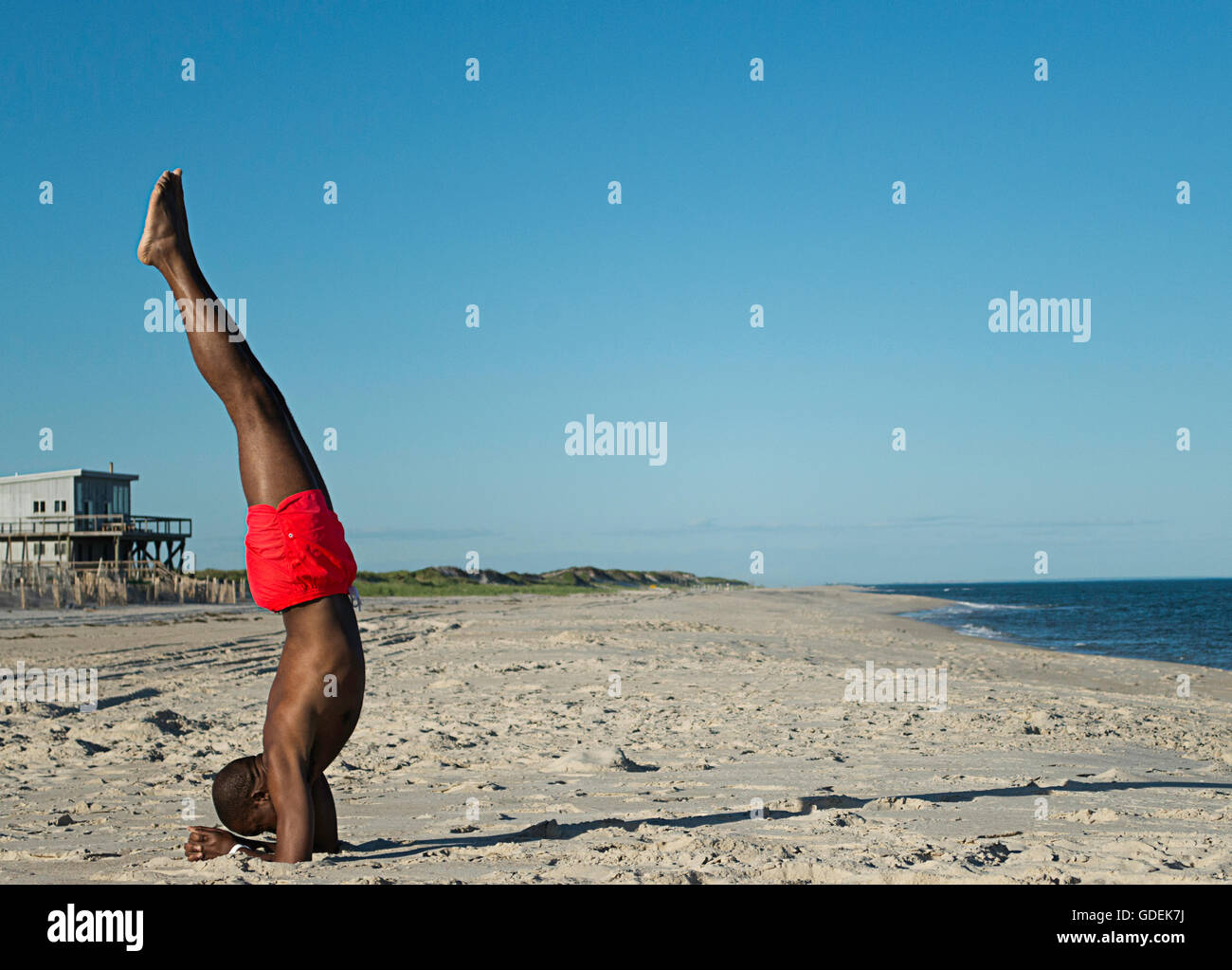 A man doing a headstand at the beach on Fire Island, New York Stock ...