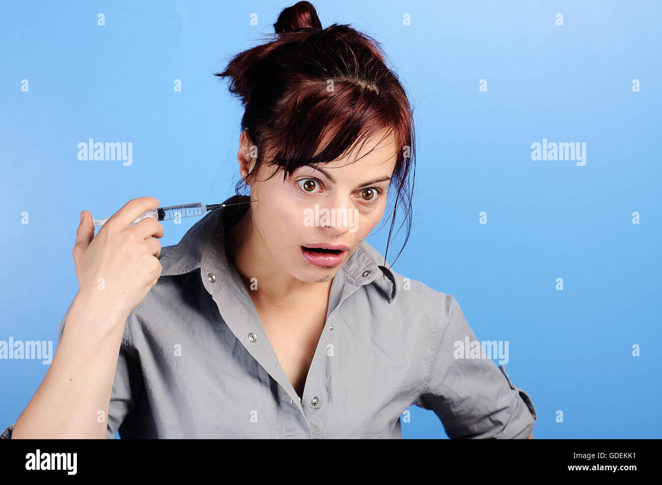 Atractive woman making a funny face injecting himself Stock Photo - Alamy