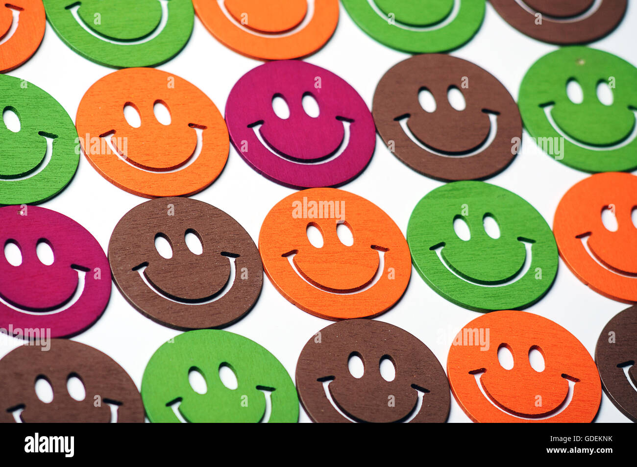 smiling wooden multi colored emoticons in row Stock Photo - Alamy