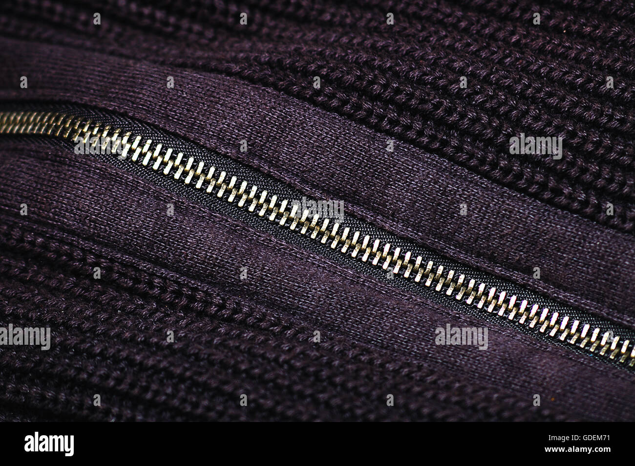golden Zipper of dark sweater. Ideally for background Stock Photo - Alamy