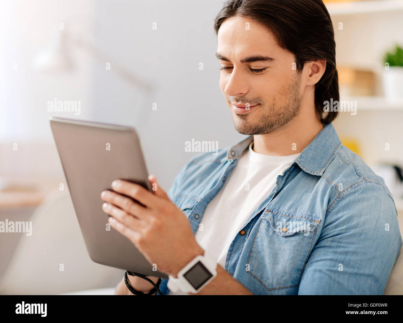 Smiling handsome man resting at home Stock Photo - Alamy