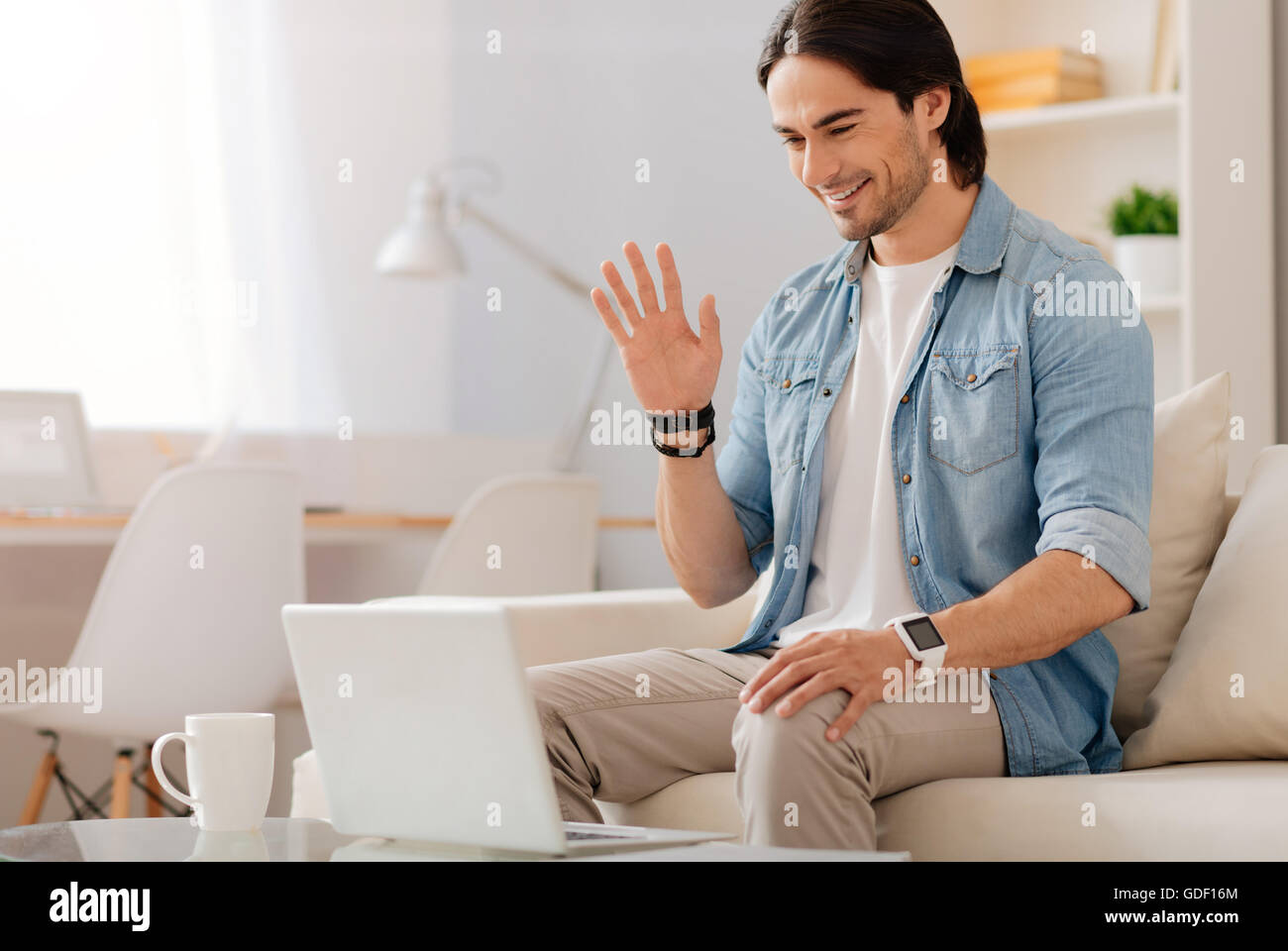 Positive smiling man talking through the Internet Stock Photo - Alamy