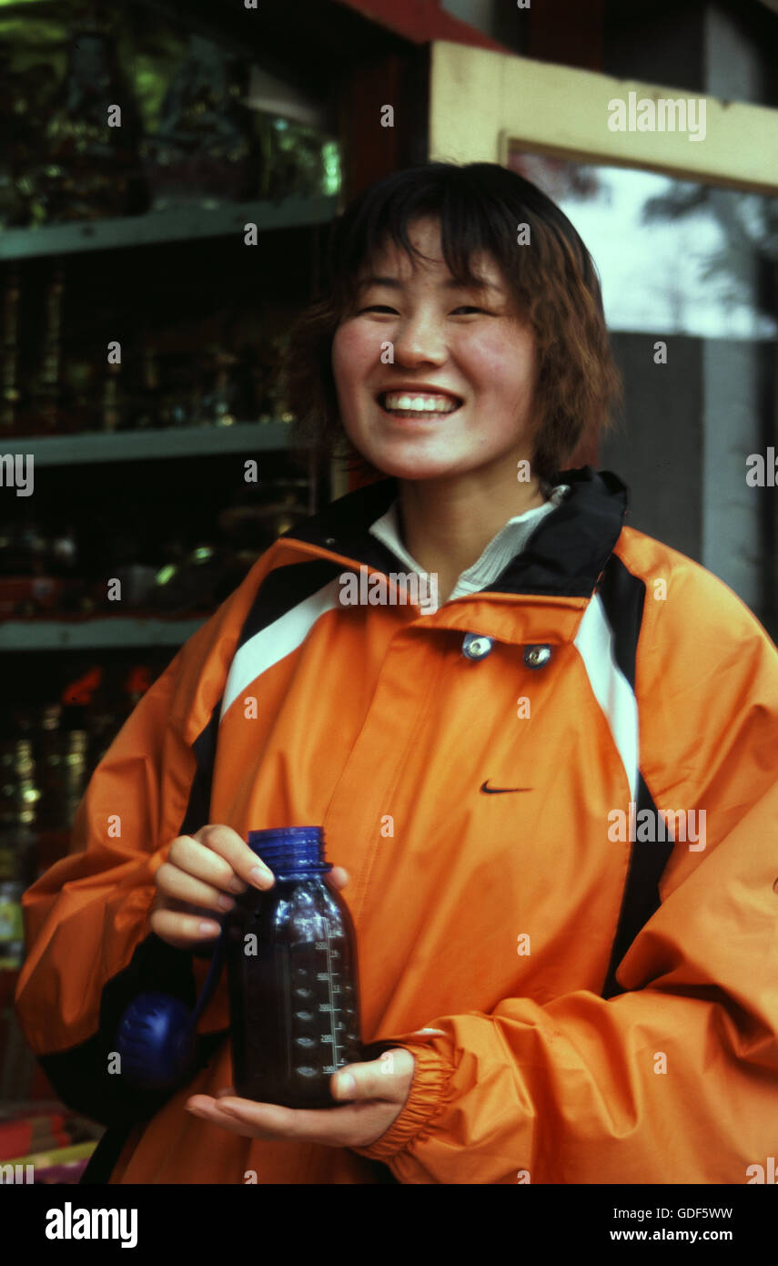 Girl selling incense on Guozijian Street in Beijing, China Stock Photo ...