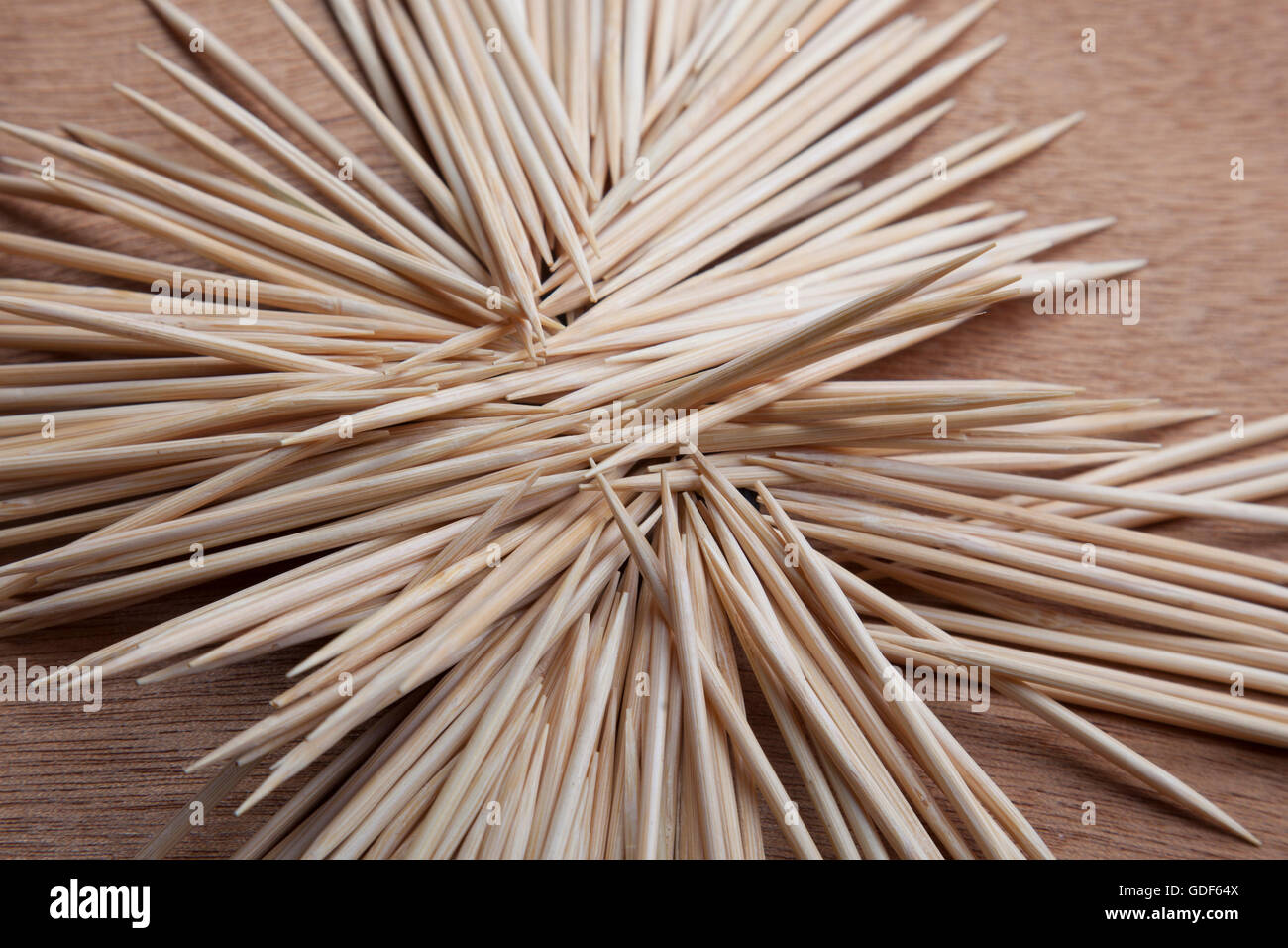 Toothpicks on a wooden surface, Pick-up sticks, look like the sun Stock ...