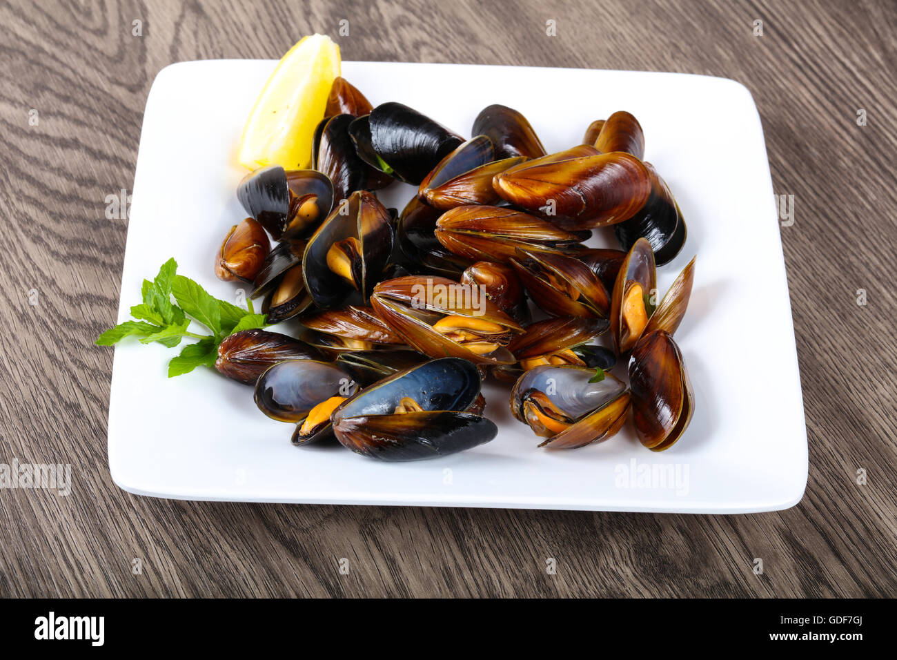 Boiled mussels with parsley on the wood background Stock Photo - Alamy