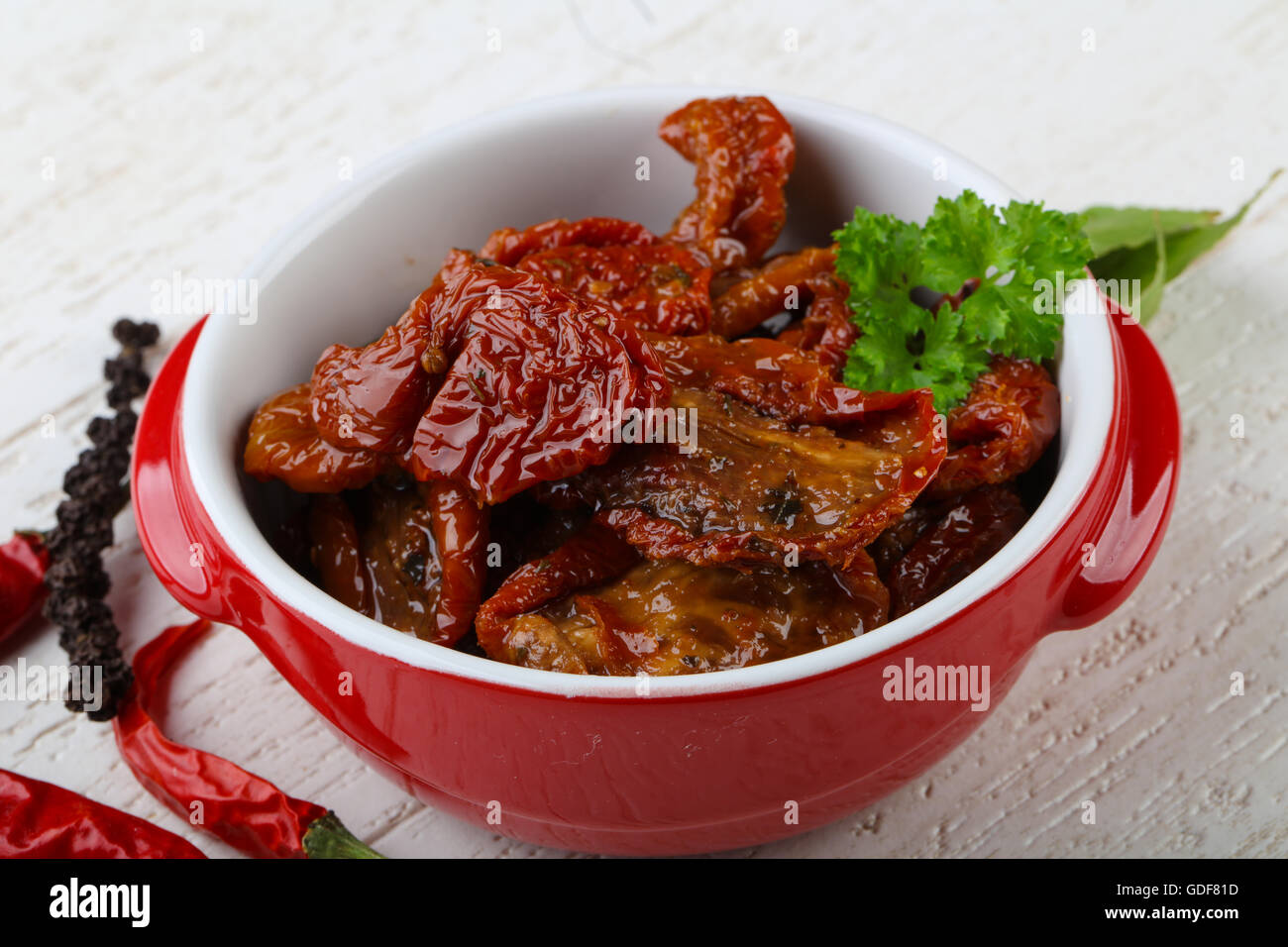 Dry tomato in olive oil with pepper Stock Photo - Alamy