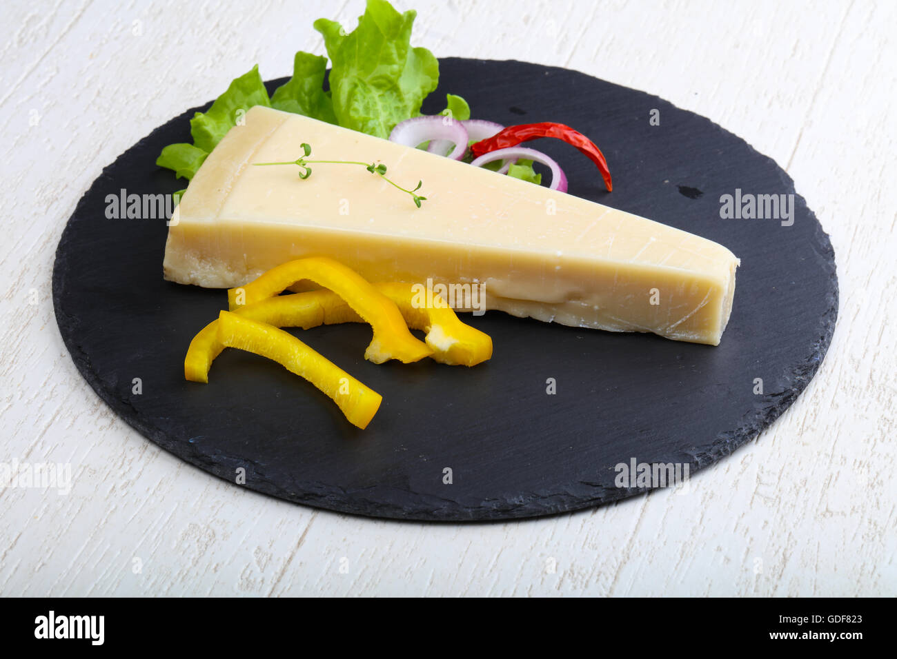 Parmesan cheese triangle on the wood background Stock Photo - Alamy
