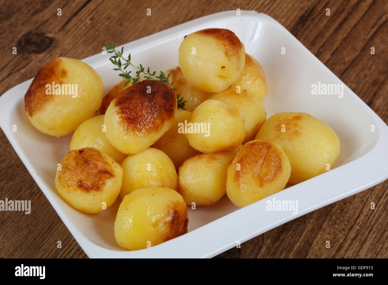 Golden backed potato with thyme branch Stock Photo - Alamy