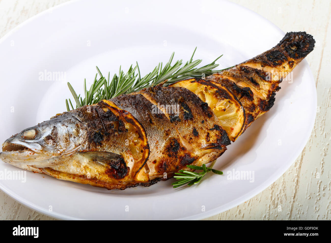 Hot fresh grilled trout with lemon and rosemary Stock Photo - Alamy