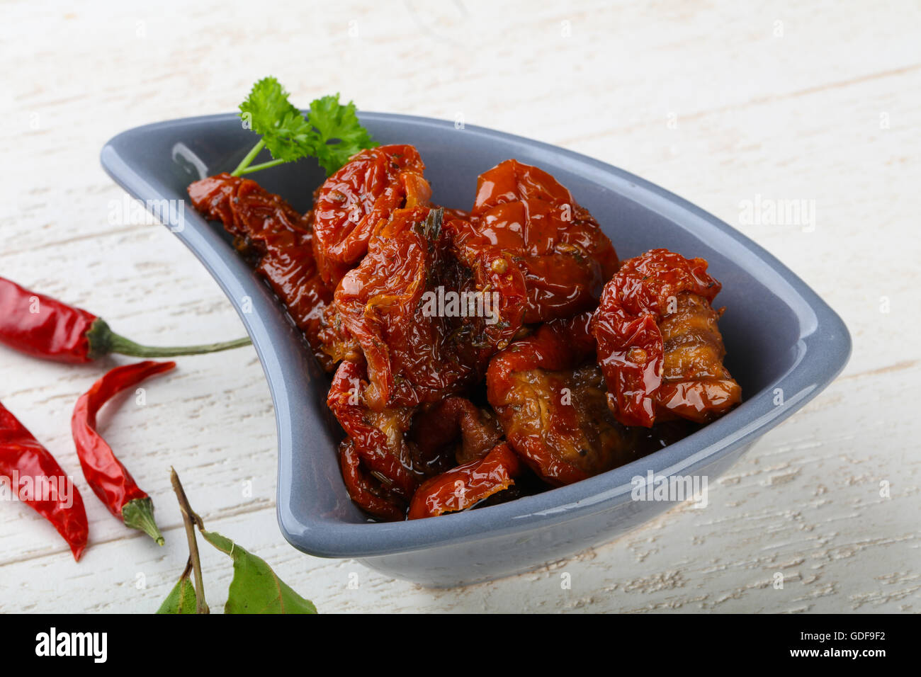 Dry tomato in olive oil with pepper Stock Photo - Alamy