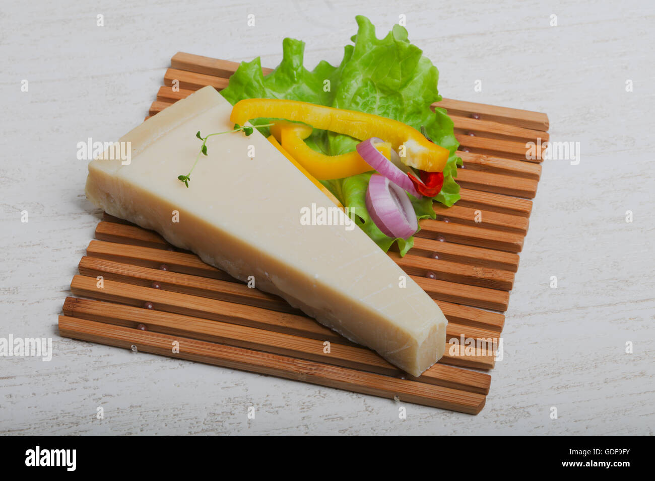 Parmesan cheese triangle on the wood background Stock Photo - Alamy
