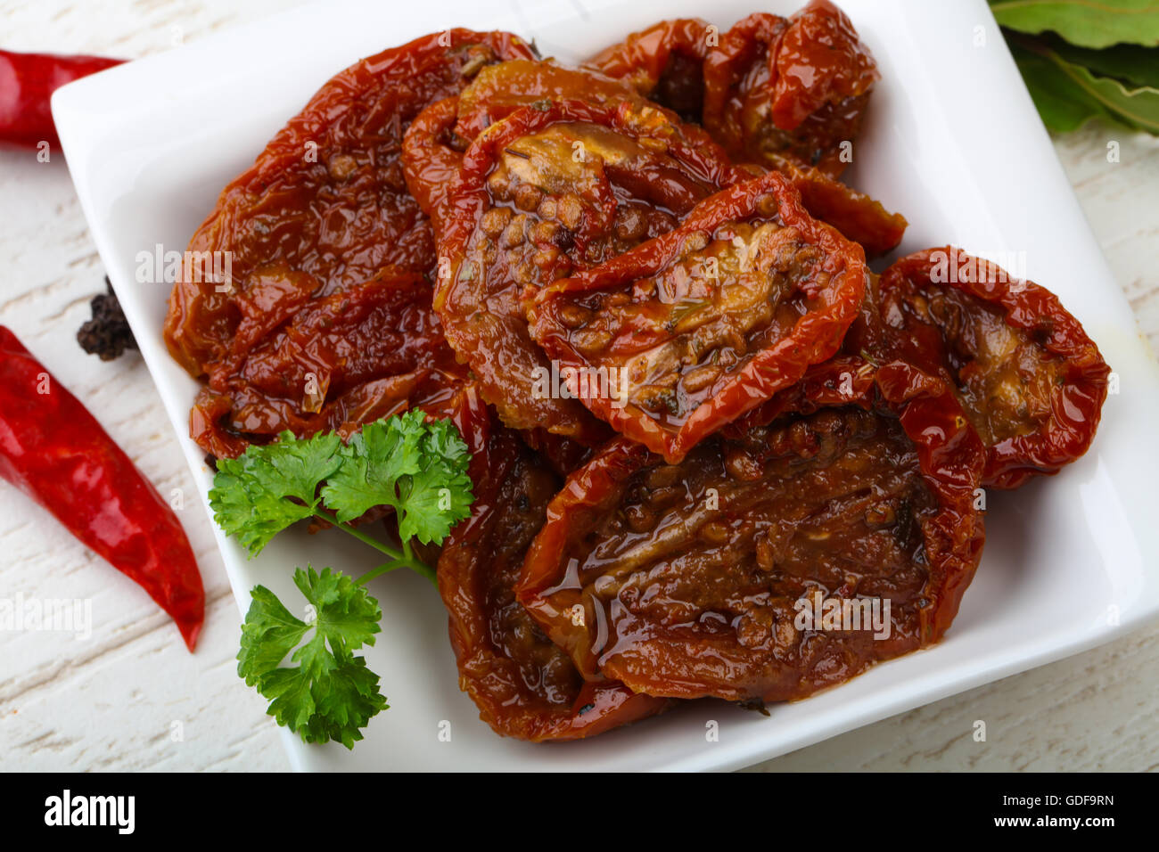 Dry tomato in olive oil with pepper Stock Photo - Alamy