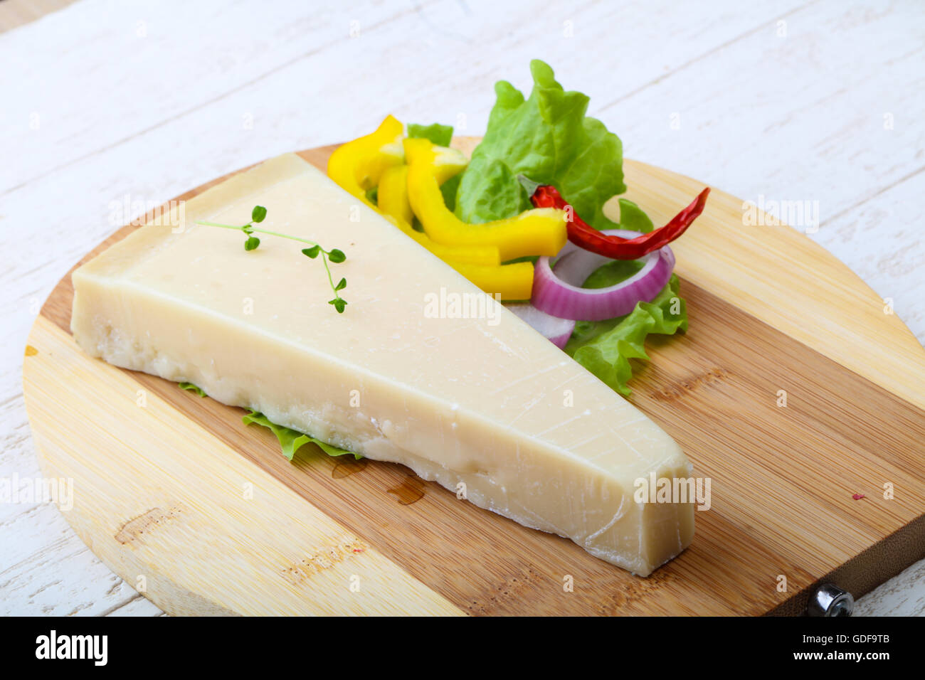 Parmesan cheese triangle on the wood background Stock Photo - Alamy