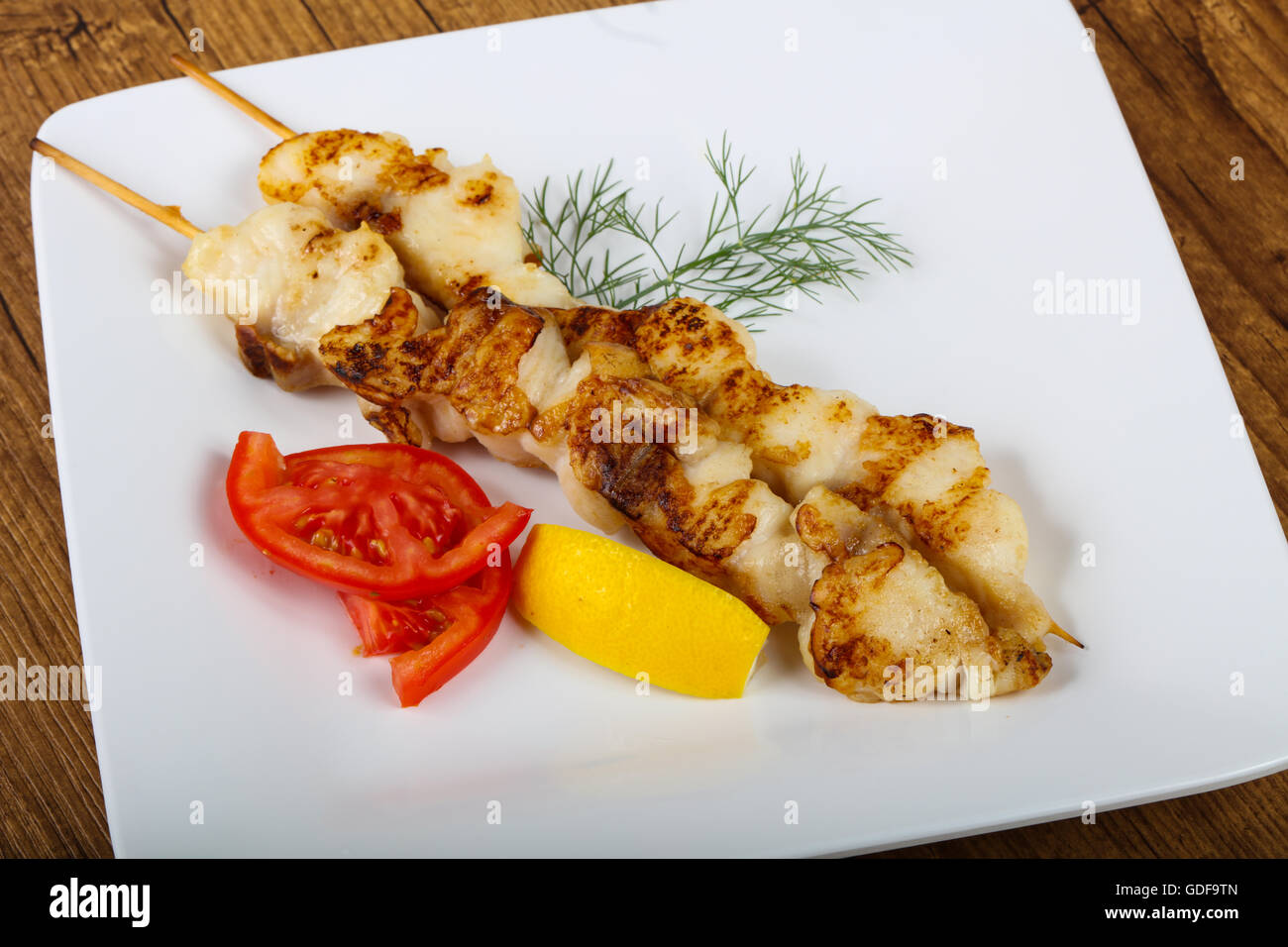 Fish skewer with dill, tomato and lemon Stock Photo - Alamy