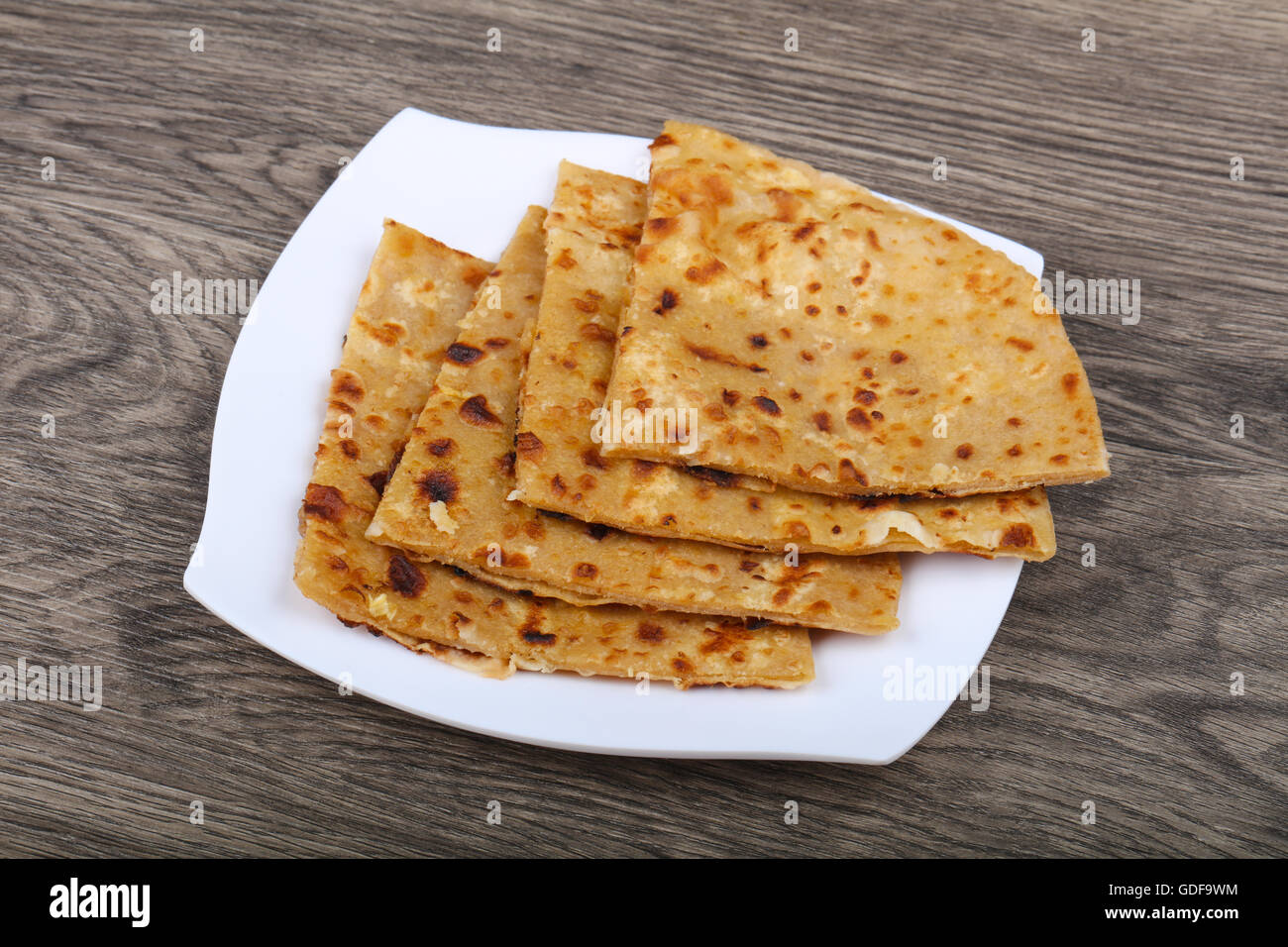 Indian bread roti on the plate in wood background Stock Photo - Alamy