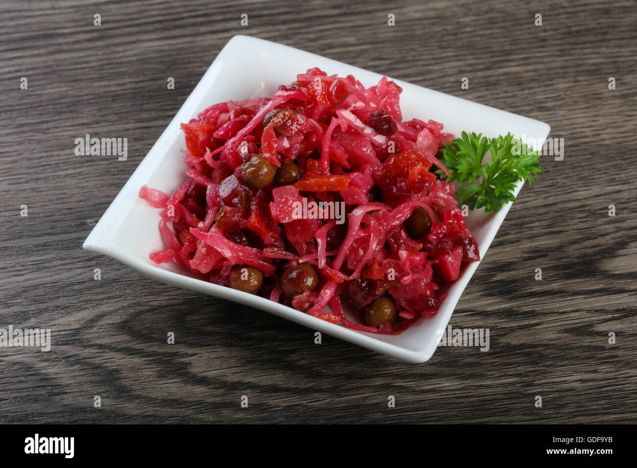 Viniagrette russian salad served parsley on wood background Stock Photo ...