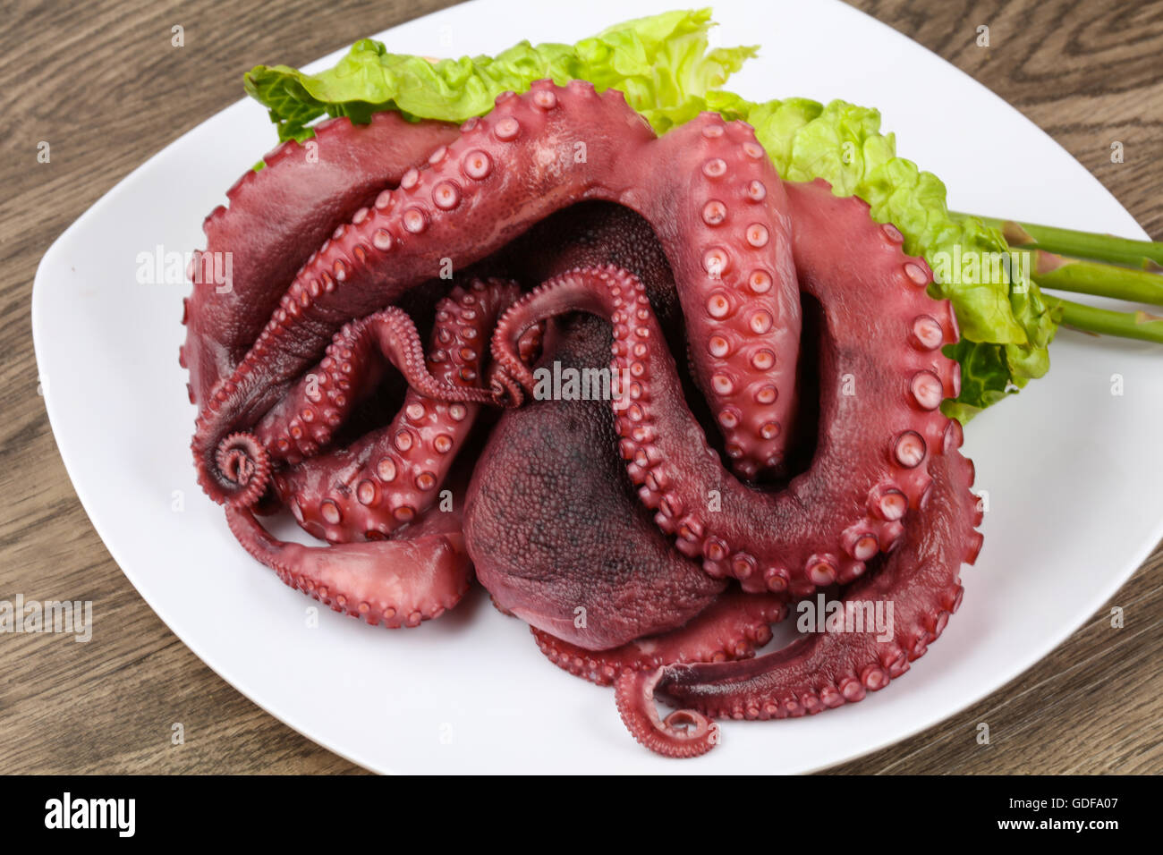 Boiled octopus ready for eat with salad leaves Stock Photo - Alamy