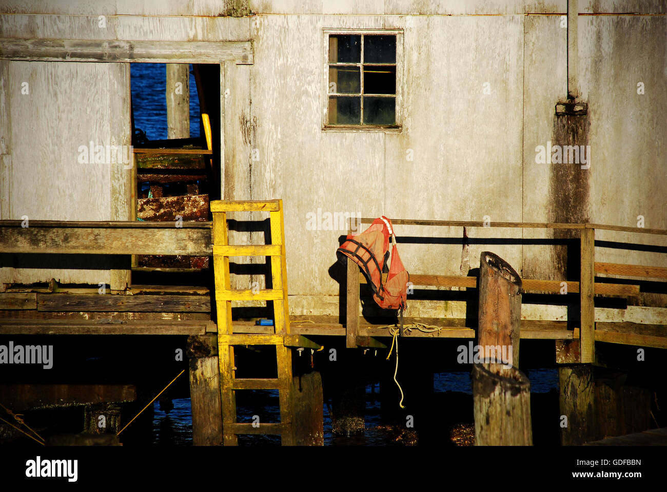 Old waterfront building with yellow ladder Stock Photo - Alamy