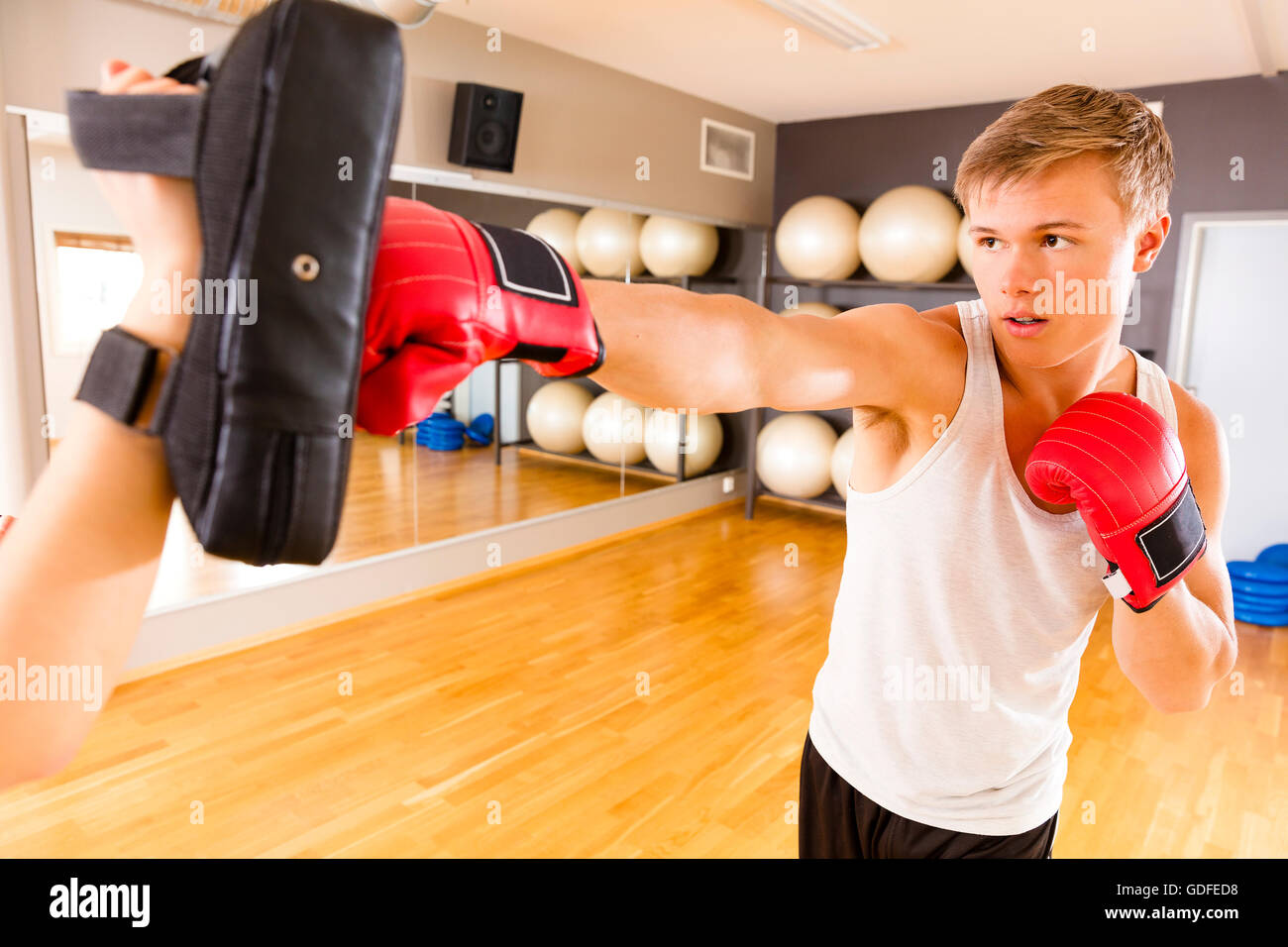 Focused man training boxing at the fitness gym Stock Photo - Alamy