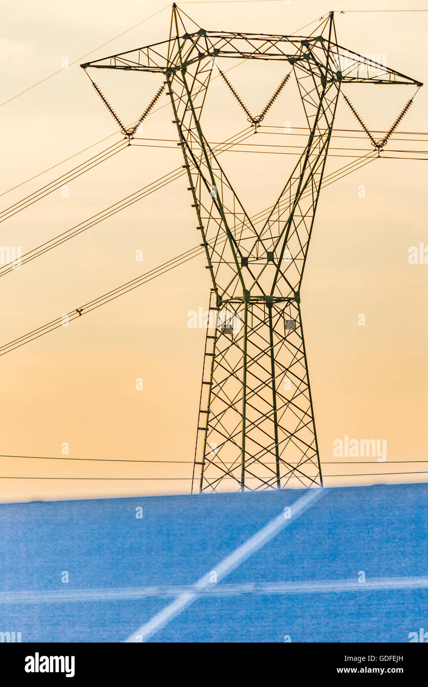 high voltage green pylon and blue photovoltaic panels Stock Photo - Alamy