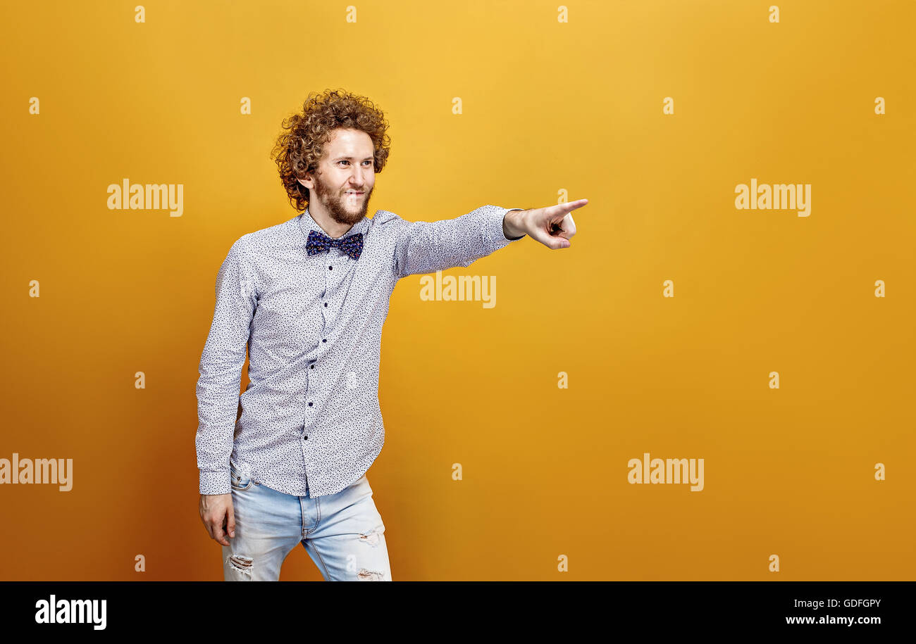 Smiling man pointing finger hi-res stock photography and images - Alamy