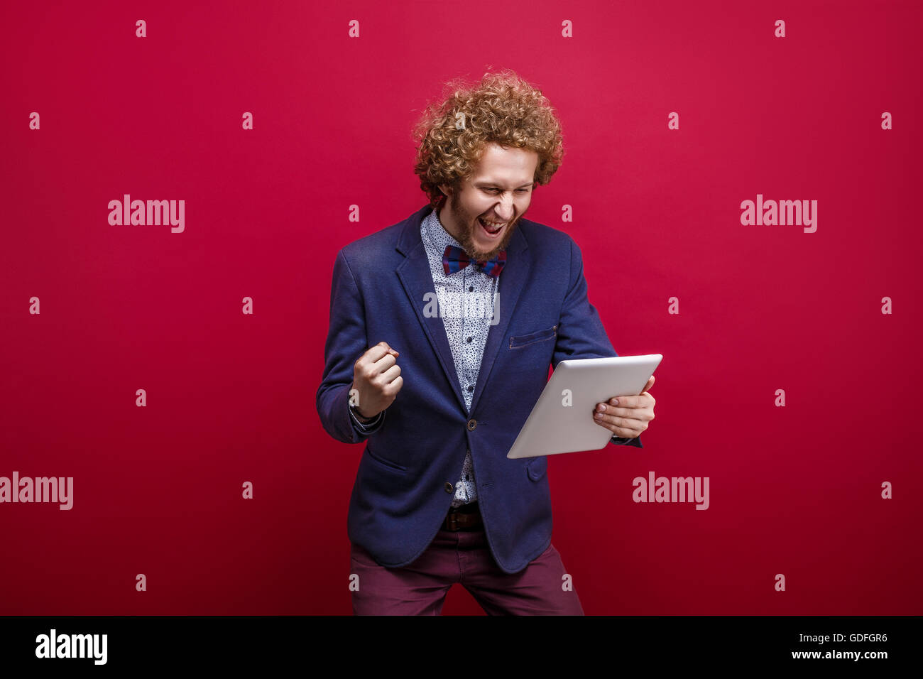 Happy man in suit using tablet Stock Photo - Alamy