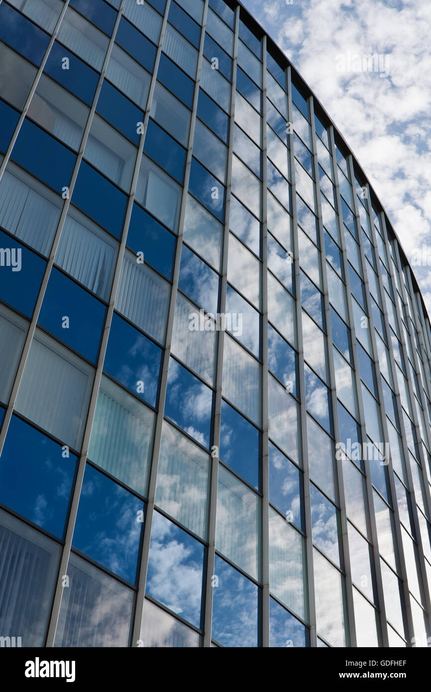High-rise glass building with cloudy sky reflection Stock Photo - Alamy