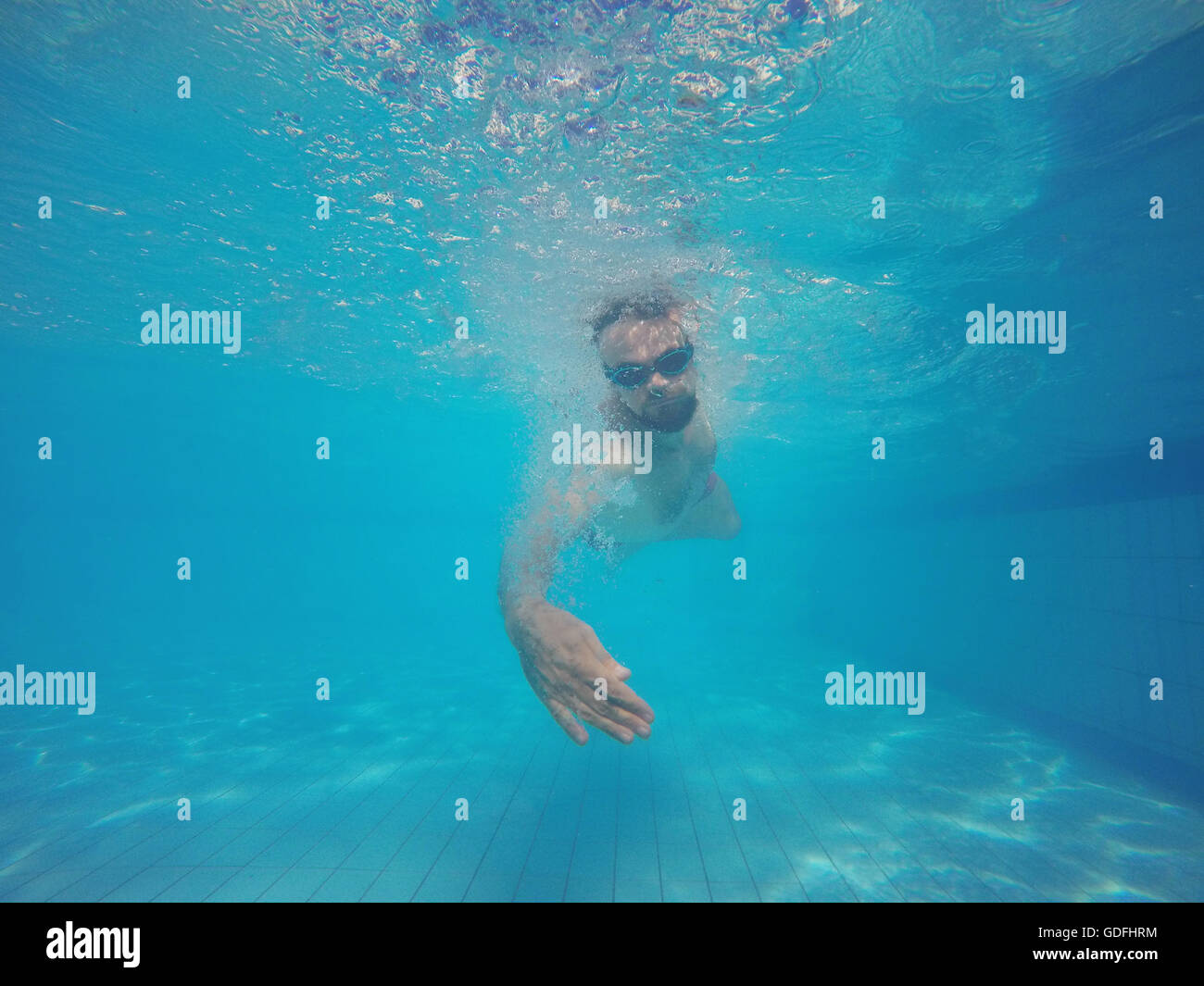 Young beard man with glasses swimming under water in the pool Stock ...