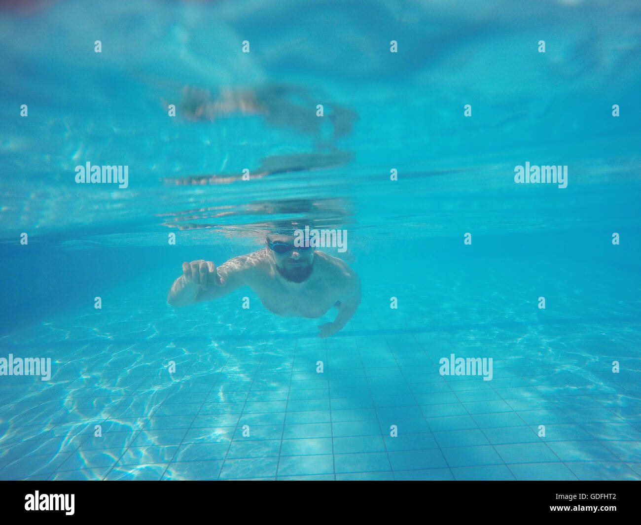 Young beard man with glasses swimming under water in the pool Stock ...