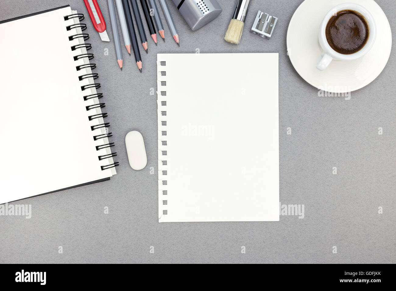 gray office desk with paper sheet, notepad, pencils and coffee cup, top ...