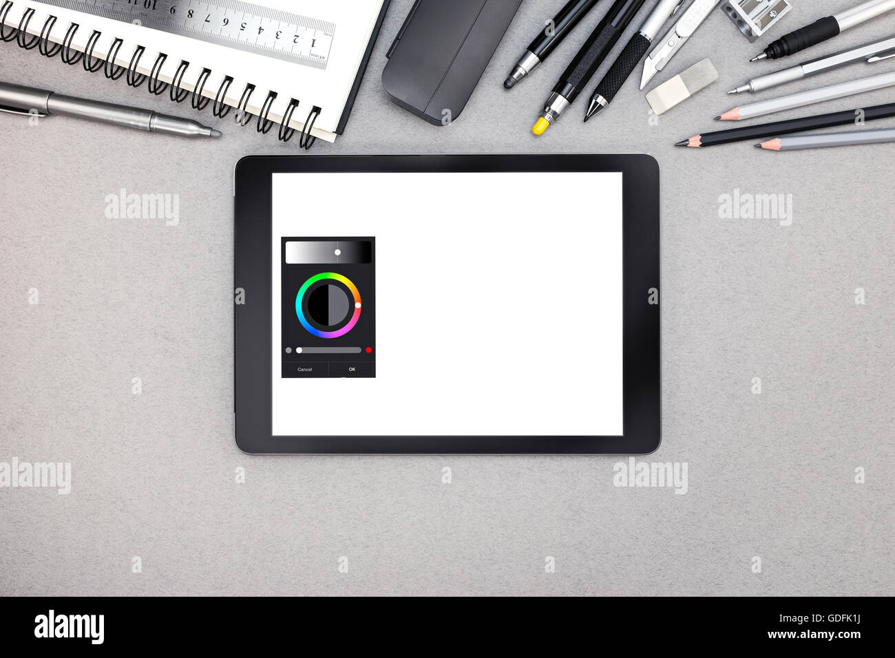 digital tablet, spiral notebook and various drawing tools on gray ...