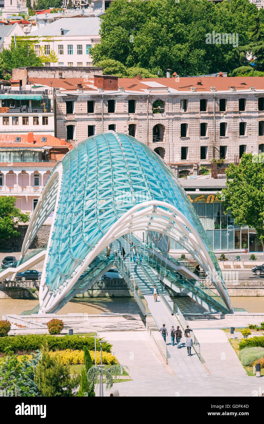 People Walking On The Bridge Of Peace Is A Bow-shaped Pedestrian Bridge ...