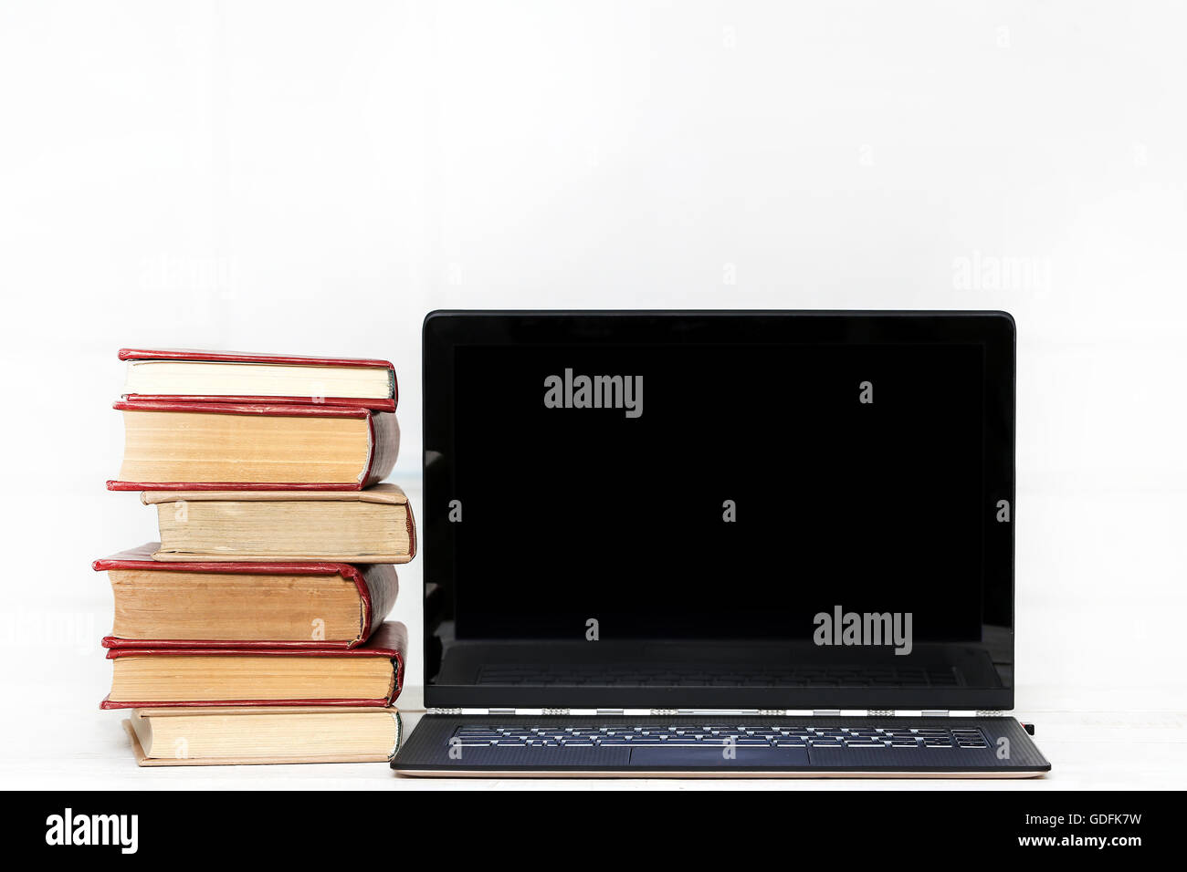 Books with laptop Stock Photo - Alamy