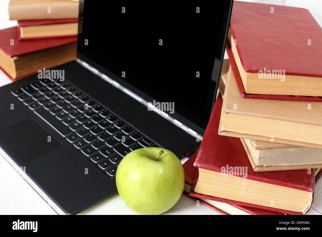 Books with laptop Stock Photo - Alamy