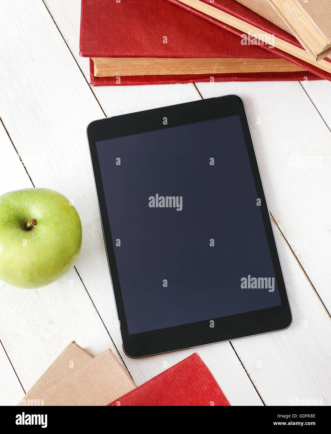 Books with tablet Stock Photo - Alamy